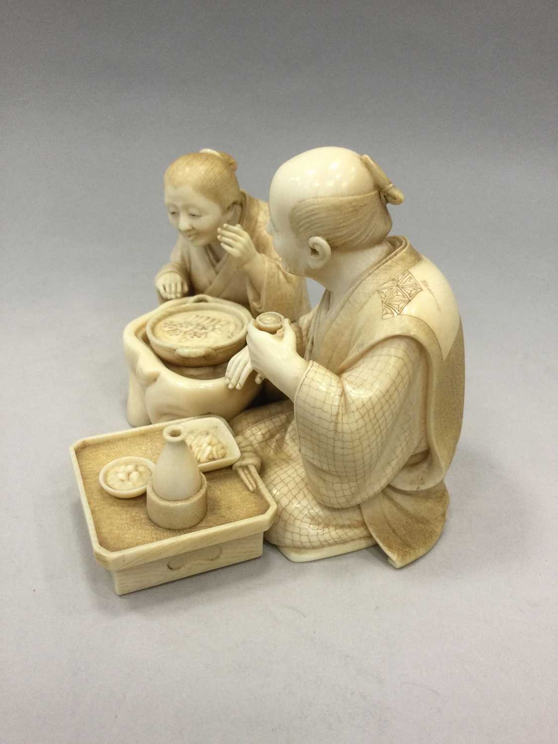 Lot 916 - A FINE JAPANESE IVORY CARVING OF A SEATED