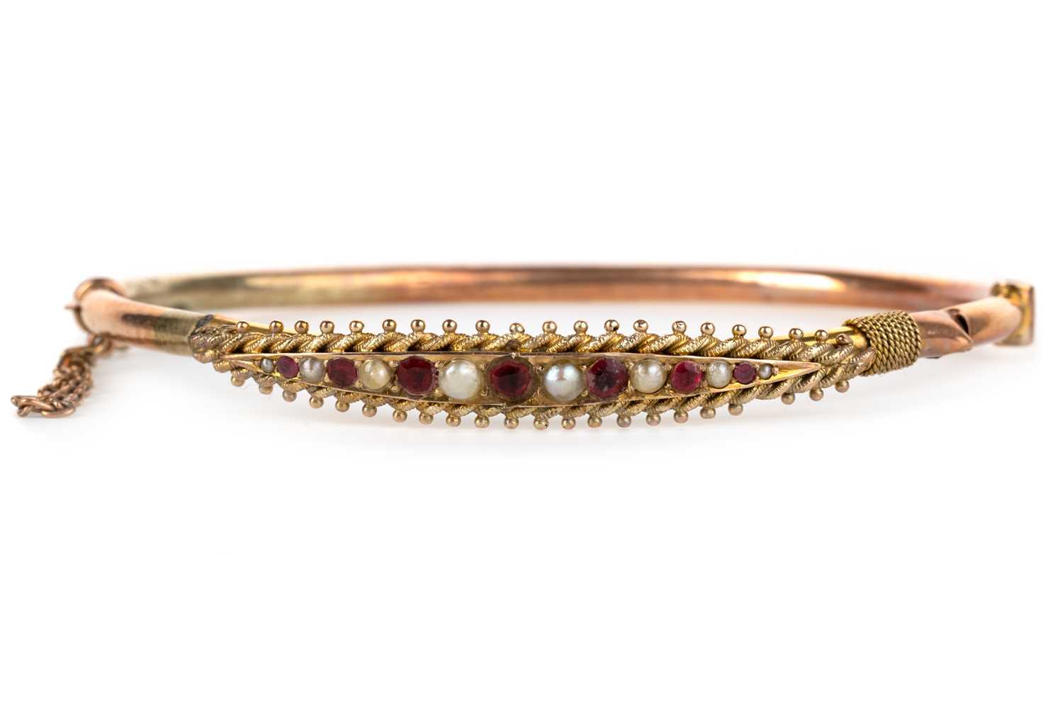 Lot 617 - VICTORIAN RUBY AND SEED PEARL BANGLE,
